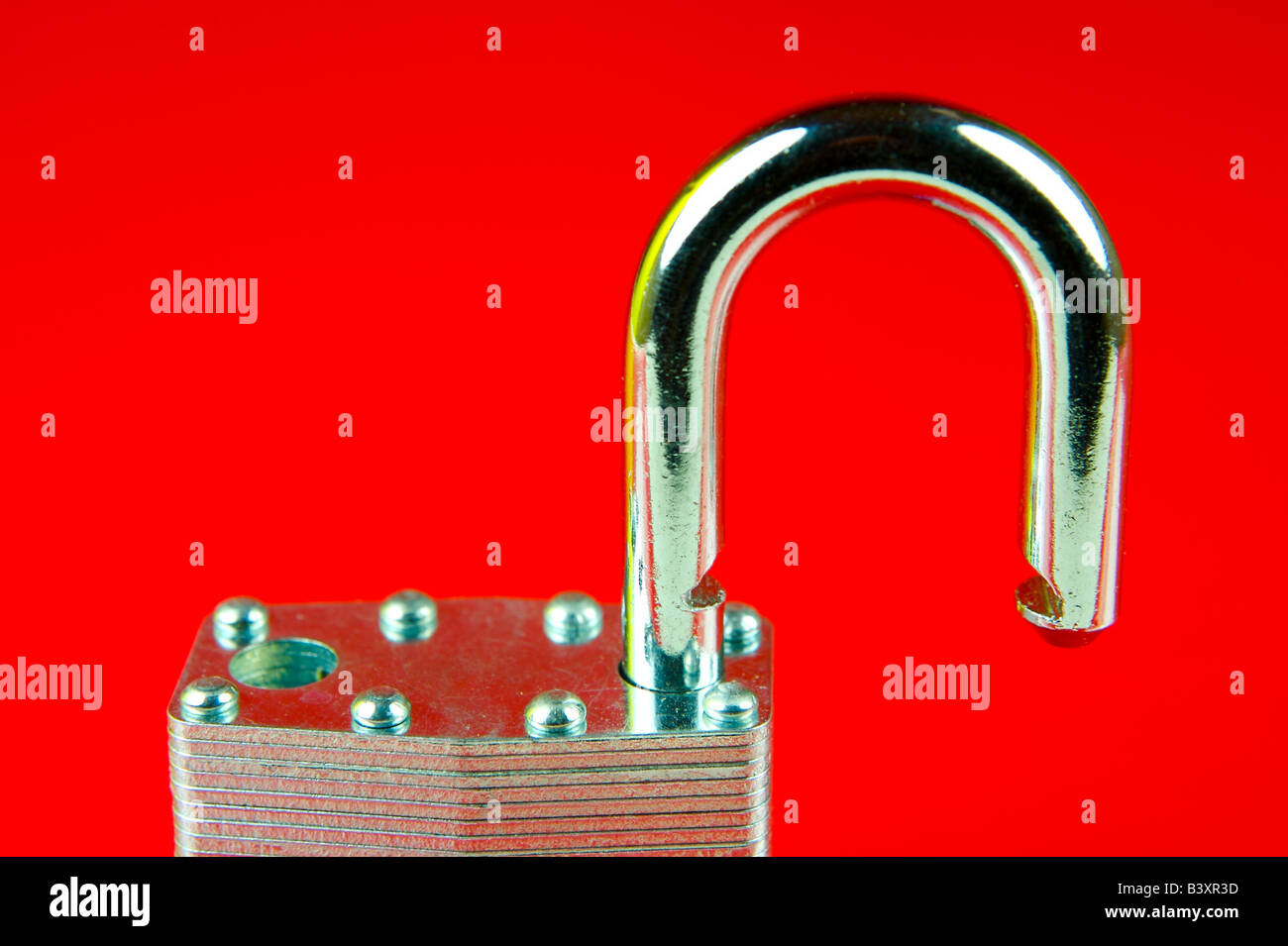 A padlock isolated against a red background Stock Photo - Alamy