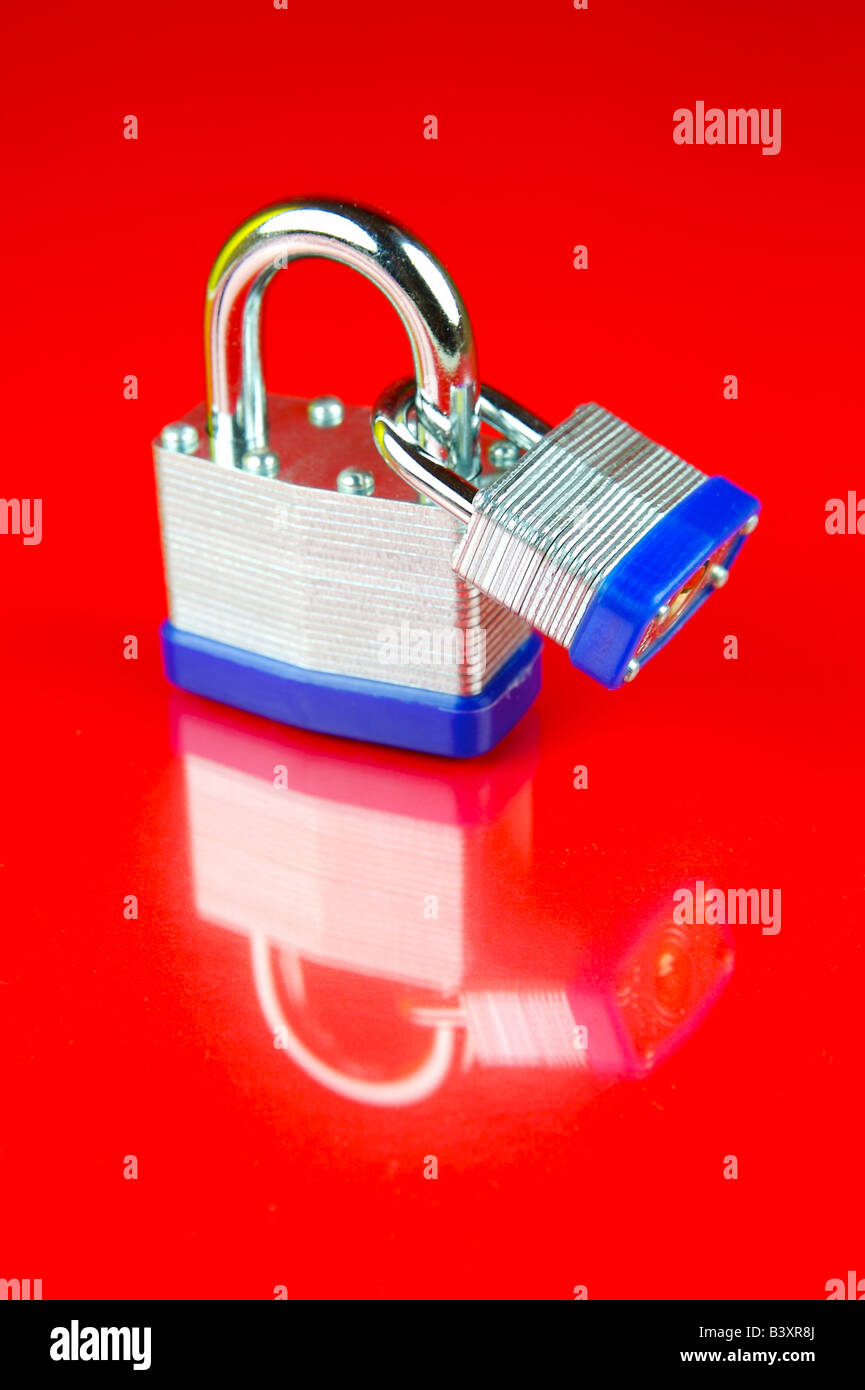 A padlock isolated against a red background Stock Photo - Alamy