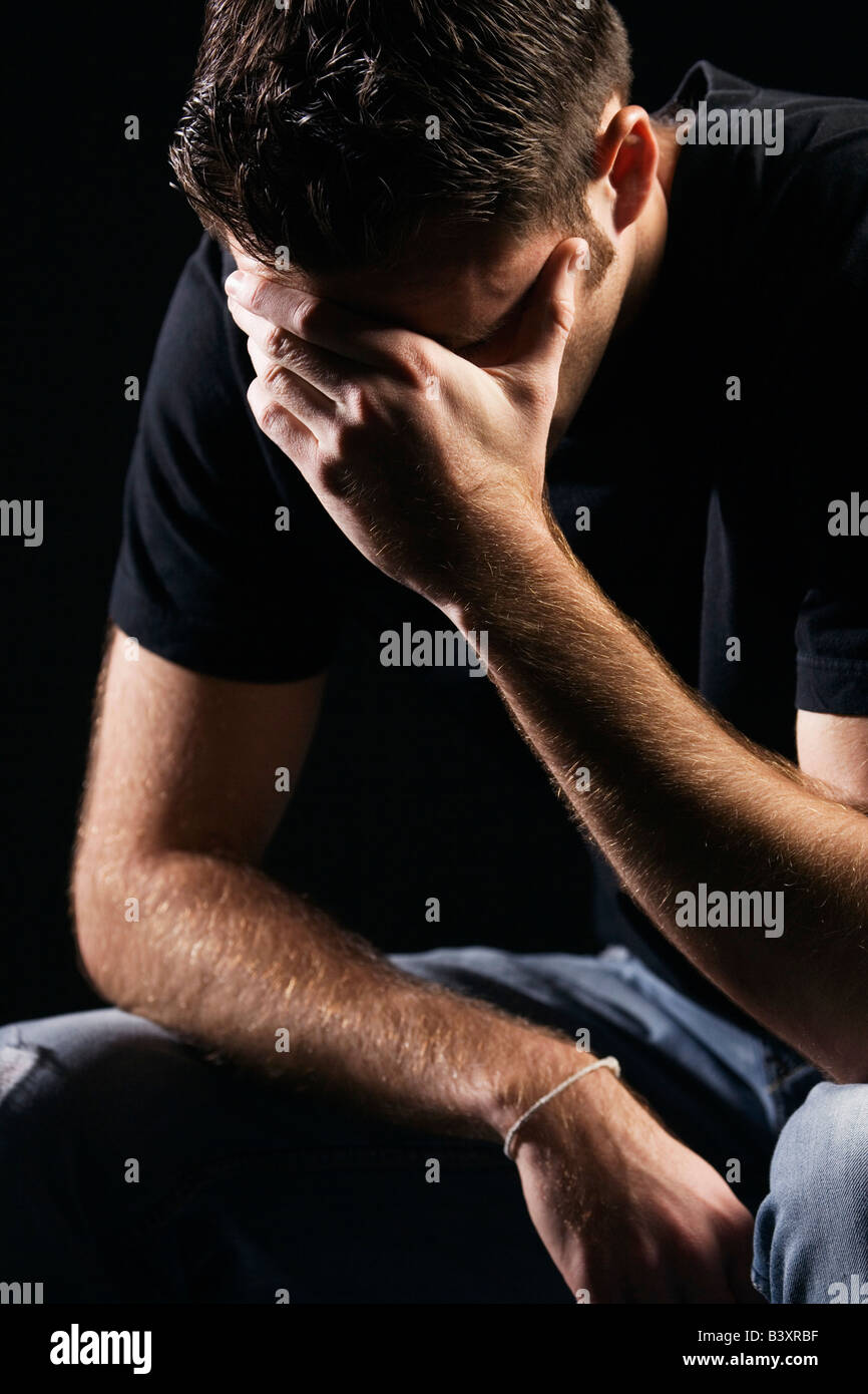 Man with hand over his face Stock Photo - Alamy