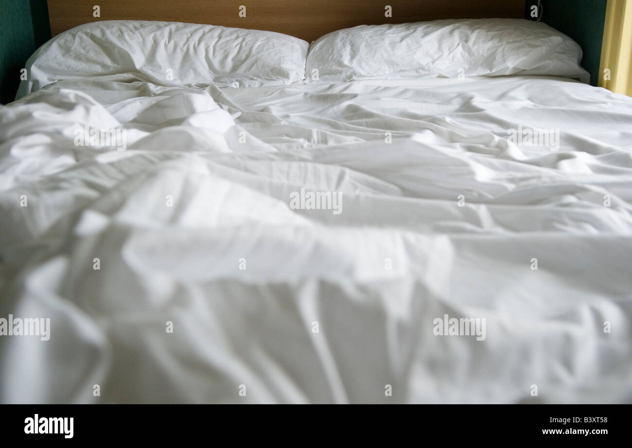 Unmade bed white bed sheets crumpled rumpled disheveled HOMER SYKES ...