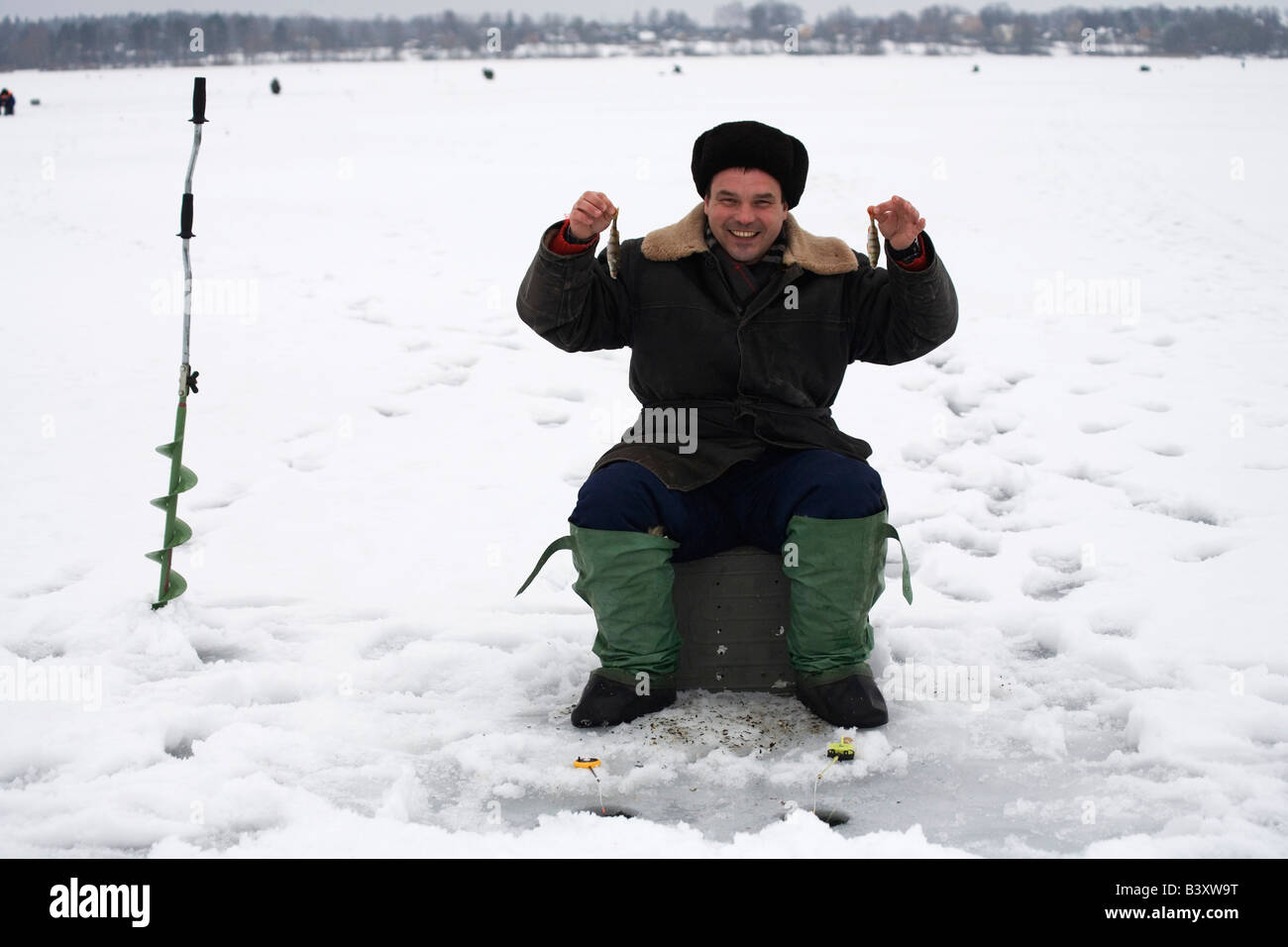 Russian fisherman fishing on a frozen lake Stock Photo - Alamy