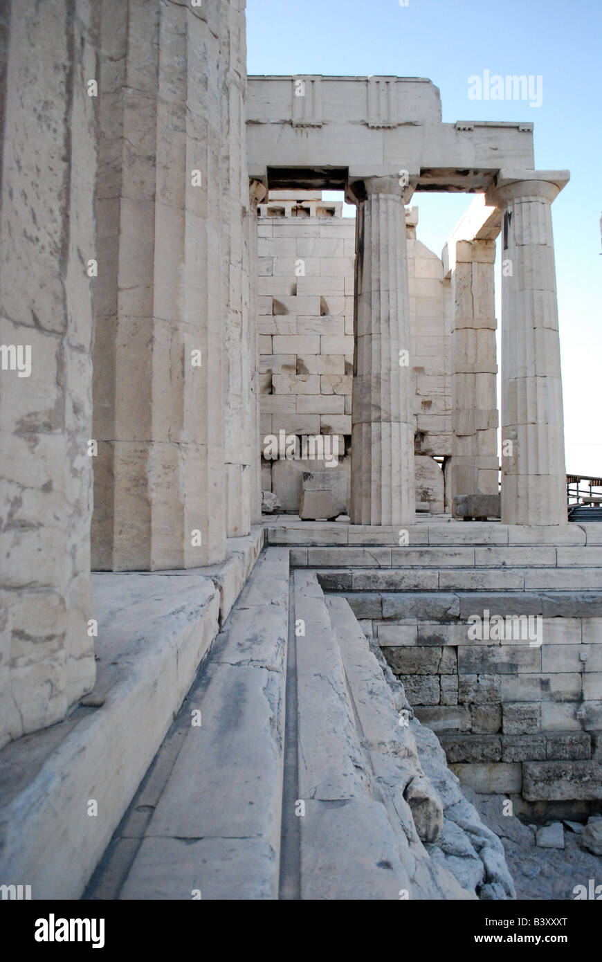 The marble Propylaia entrance to the Acropolis against a bright blue ...