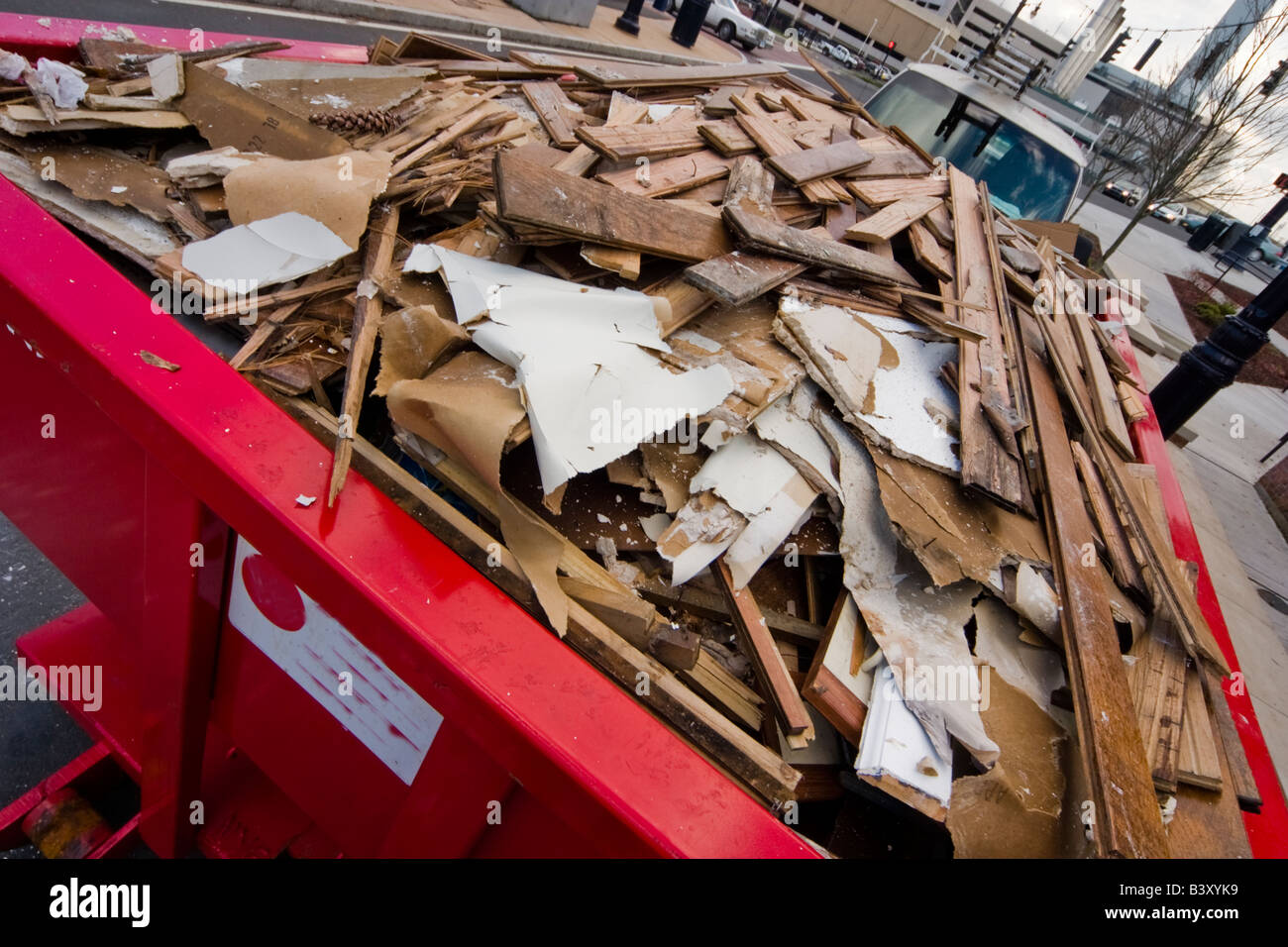 Discarded building material in a large dumpster Stock Photo - Alamy