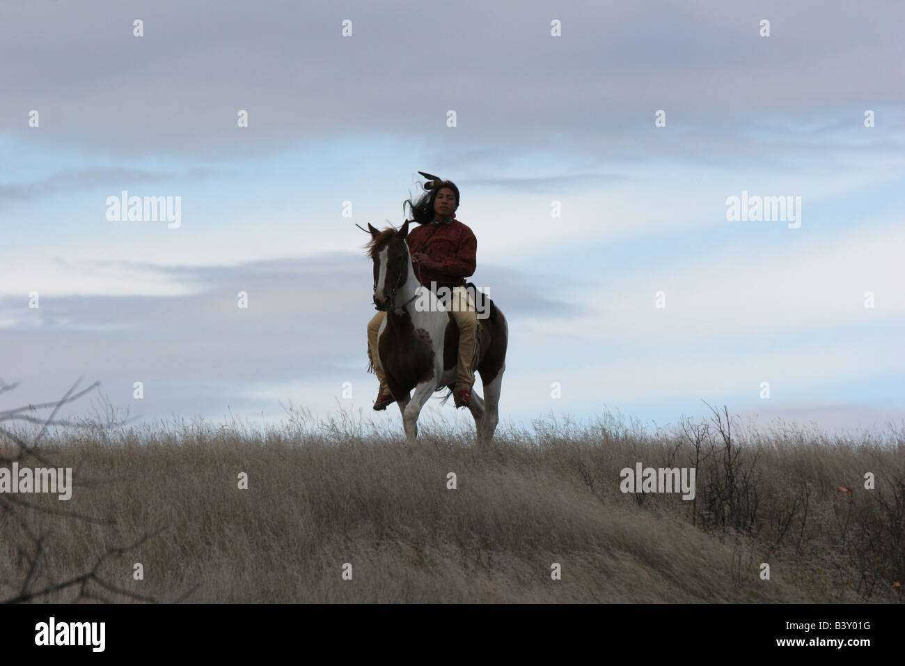 A Native American Indian boy on horseback on the prairie of South ...