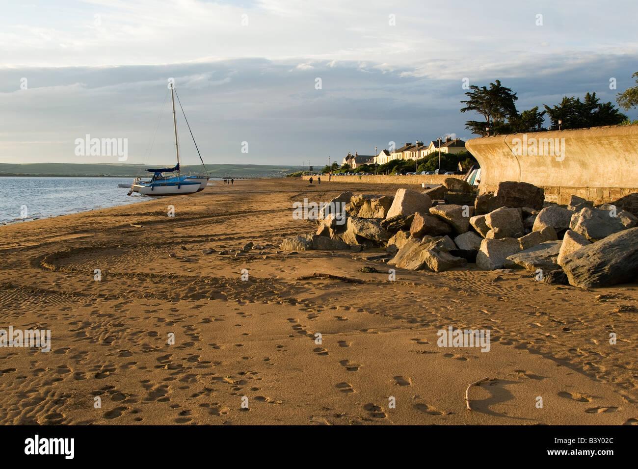 Instow beach north Devon golden evening light with boat in the distance ...