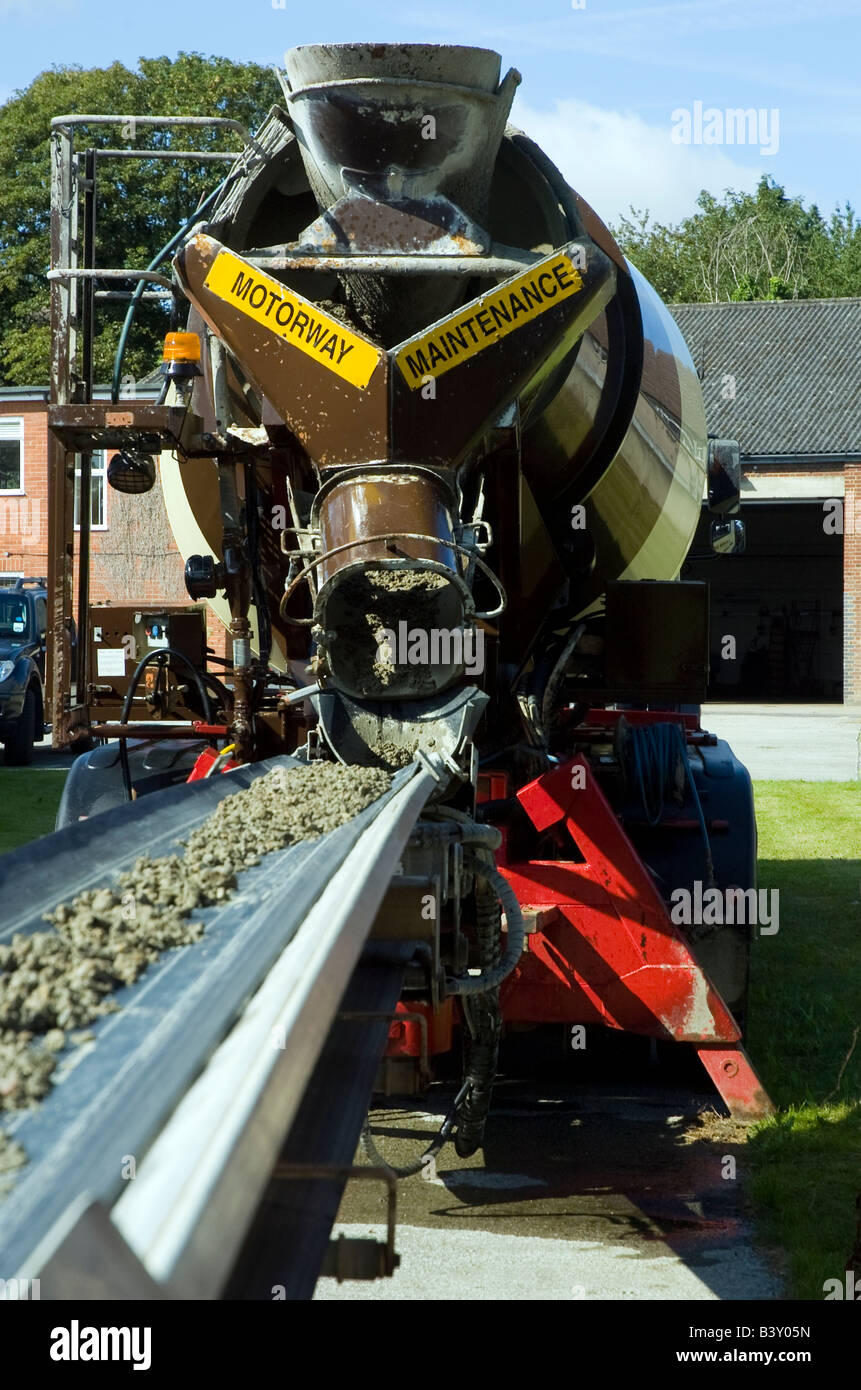 A cement mixer is pouring out cement concrete Stock Photo - Alamy