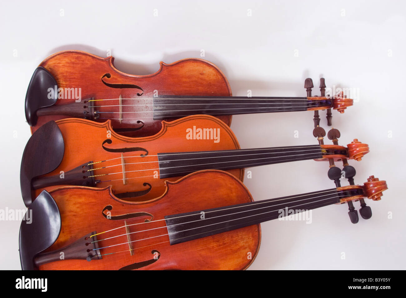 Three violins, front view Stock Photo - Alamy