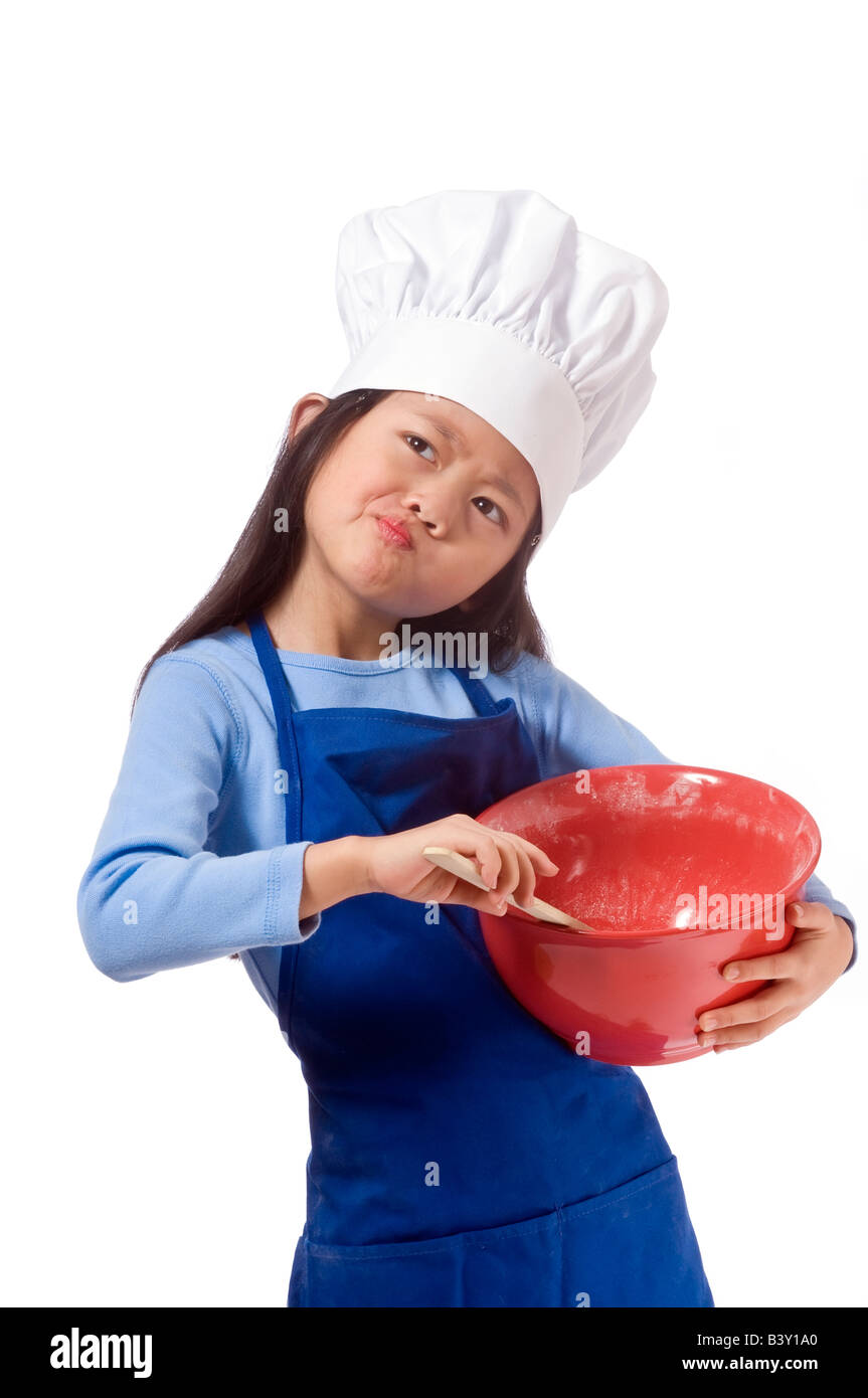 A young girl having fun in the kitchen making a mess I mean making ...
