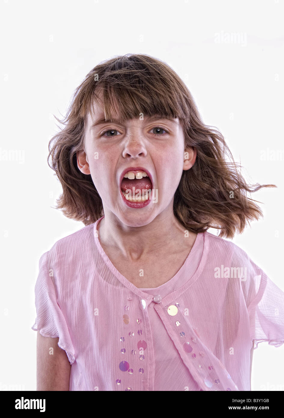 Young angry girl with mouth open yelling isolated on white background ...