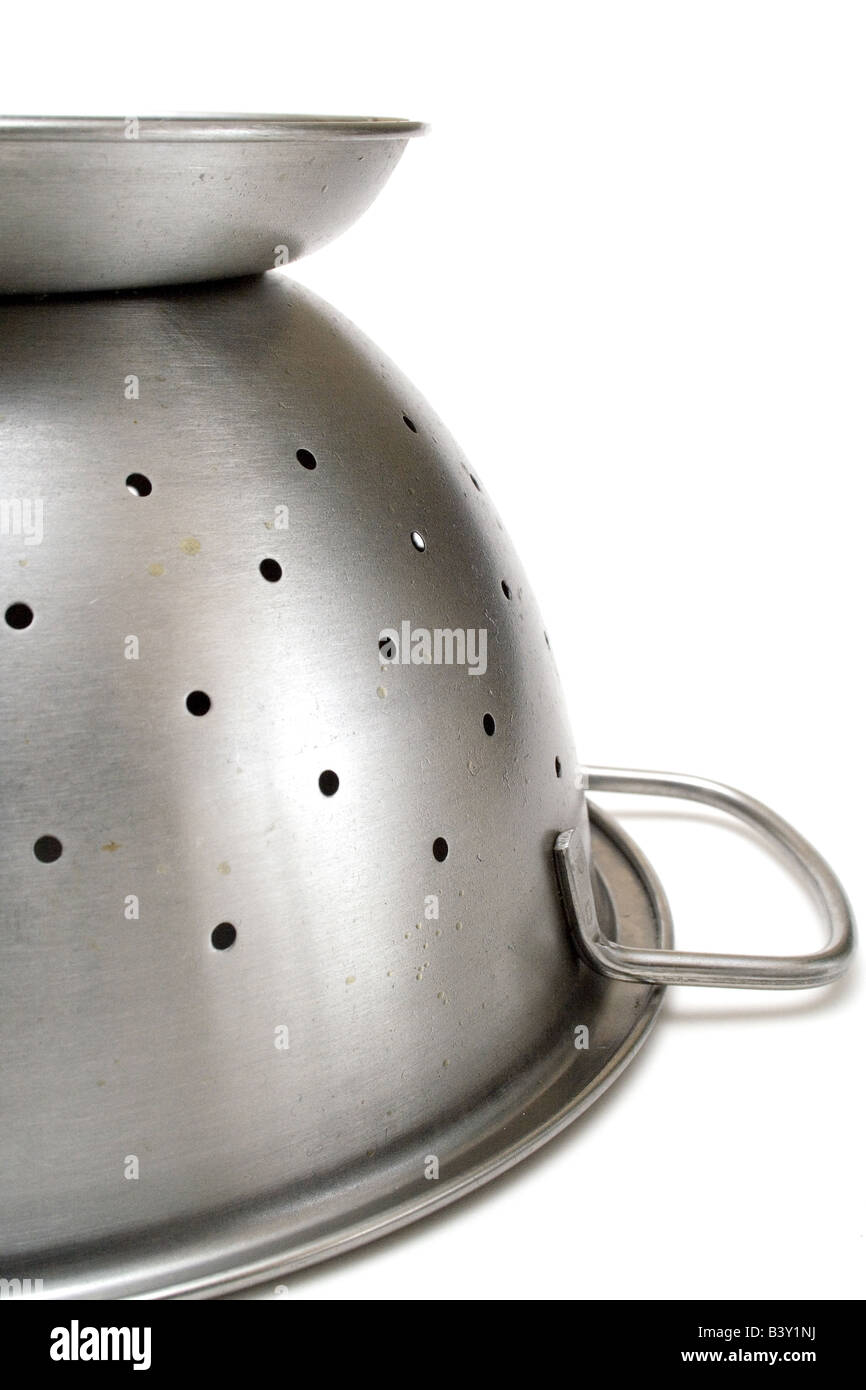 A greasy upturned collander isolated on a white background Focus is on ...