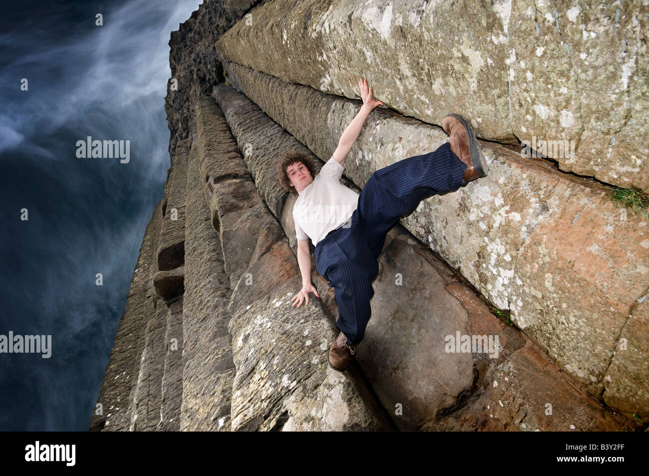 Man Climbing On The "pipe organ". Giants Causeway, Northern Ireland ...