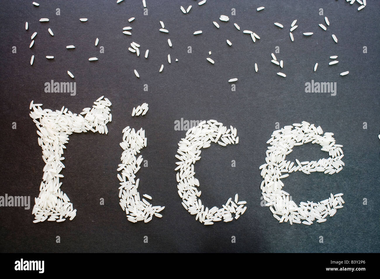 Rice grains spelling the word rice on a dark background Stock Photo - Alamy