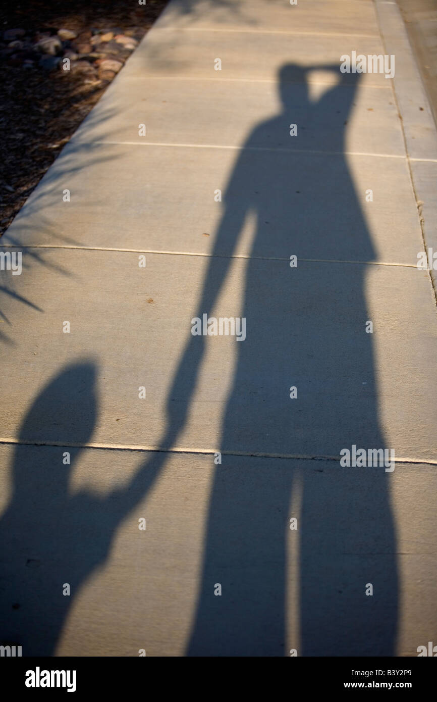 Shadow of young boy and Father walking on sidewalk Stock Photo - Alamy