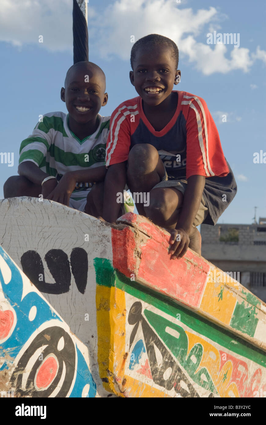 Two young Senegalese boys playing on the bow of a boat in Dakar, Senegal Stock Photo - Alamy