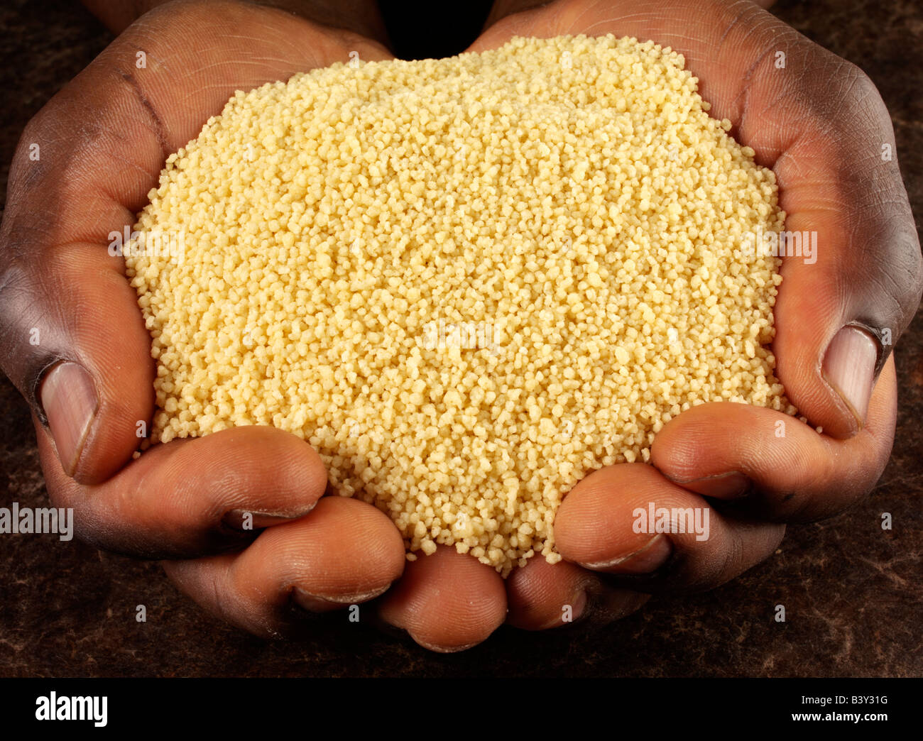 MAN'S HANDS HOLDING COUSCOUS Stock Photo - Alamy