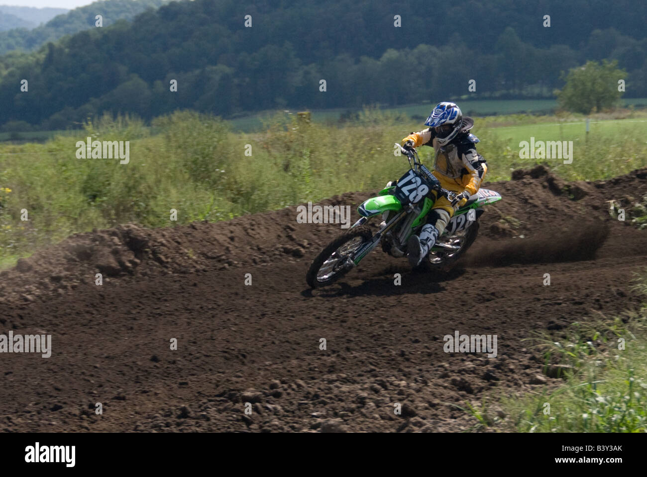Man jumping on a motocross track with sky in the background Stock Photo ...
