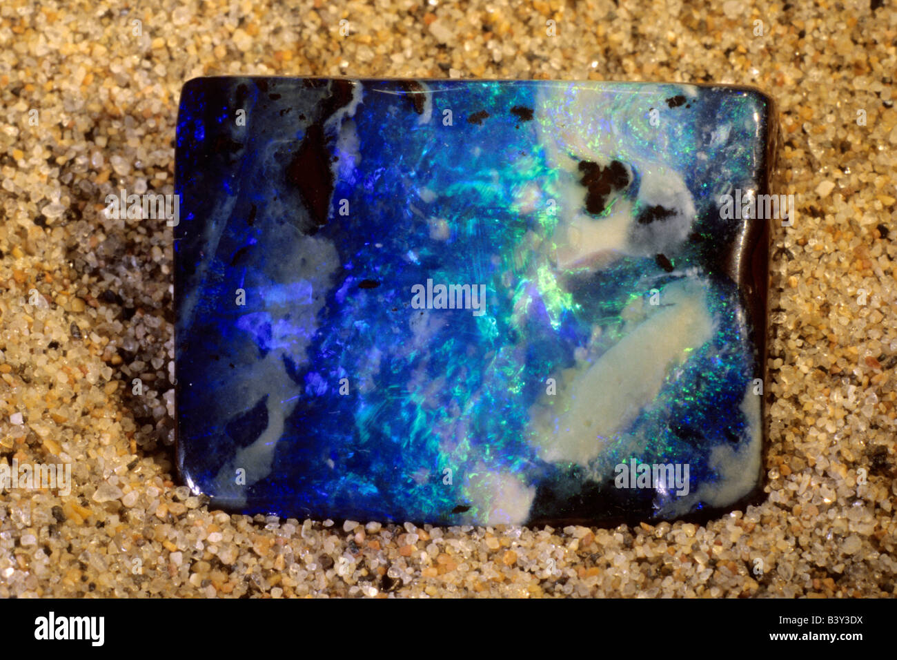 Precious Opal on sand Stock Photo - Alamy