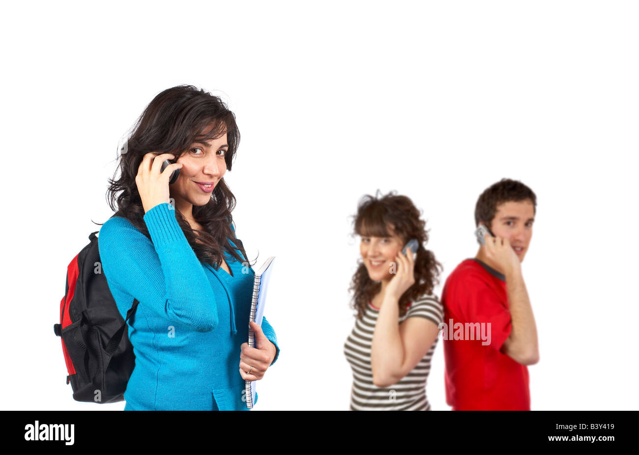 Three students with books and backpacks Stock Photo - Alamy