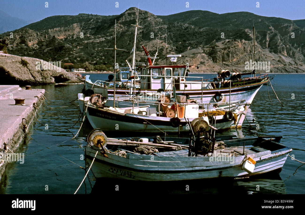 Greek fishing boats moored in a small fishing village in Crete Stock ...