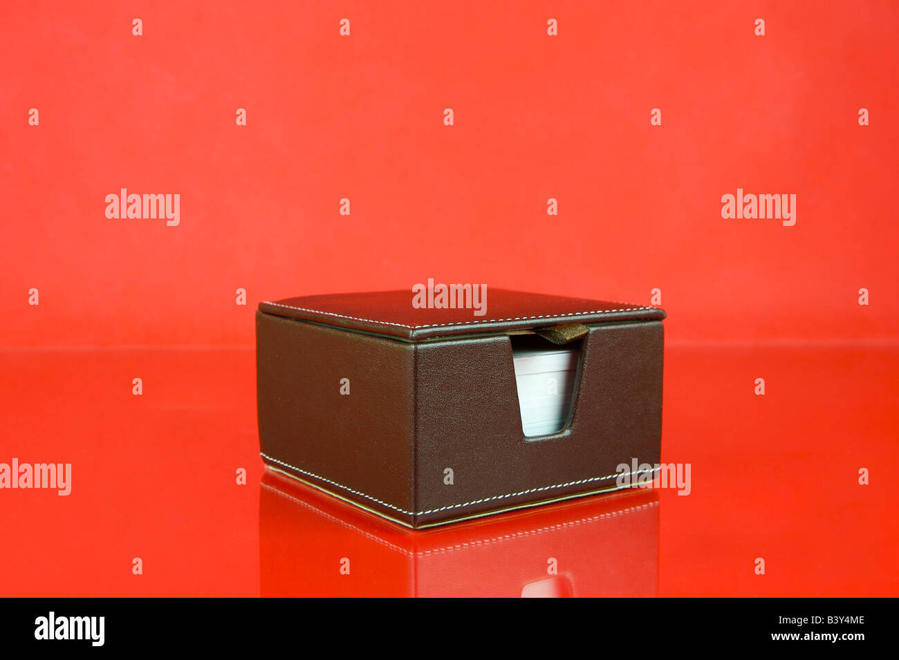 A note block isolated against a red background Stock Photo - Alamy