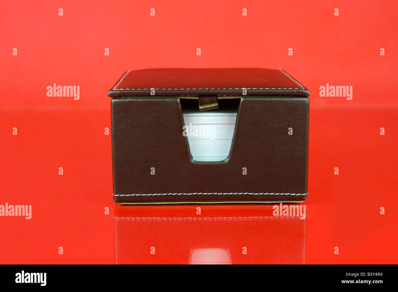 A note block isolated against a red background Stock Photo - Alamy