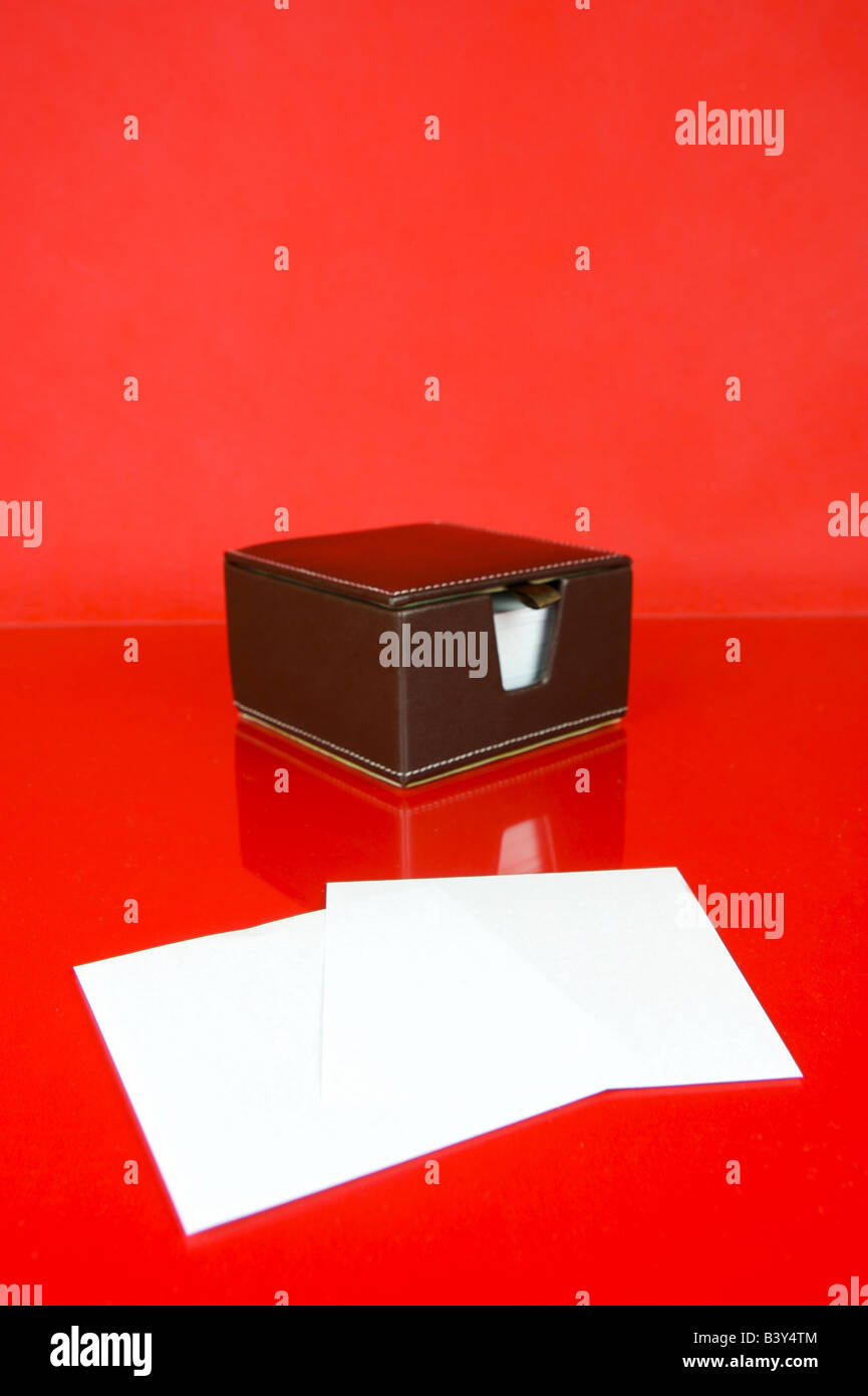 A note block isolated against a red background Stock Photo - Alamy