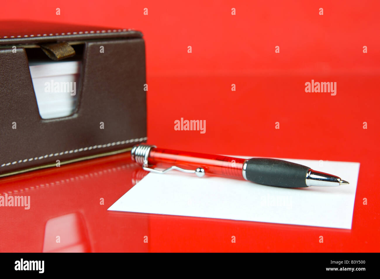 A note block isolated against a red background Stock Photo - Alamy