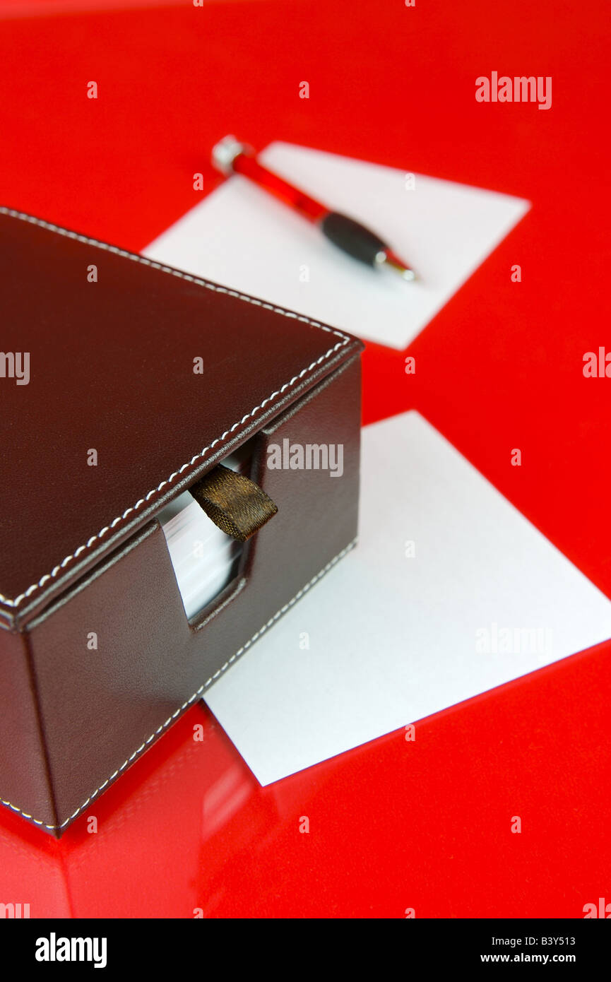 A note block isolated against a red background Stock Photo - Alamy