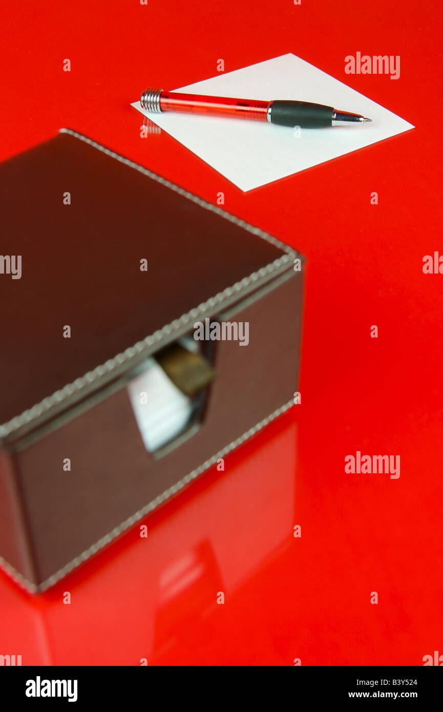 A note block isolated against a red background Stock Photo - Alamy