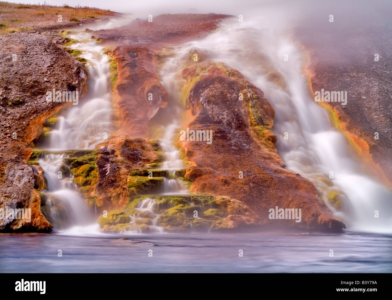 Hot springs waterfall flowing into the Firehole River Yellostone ...
