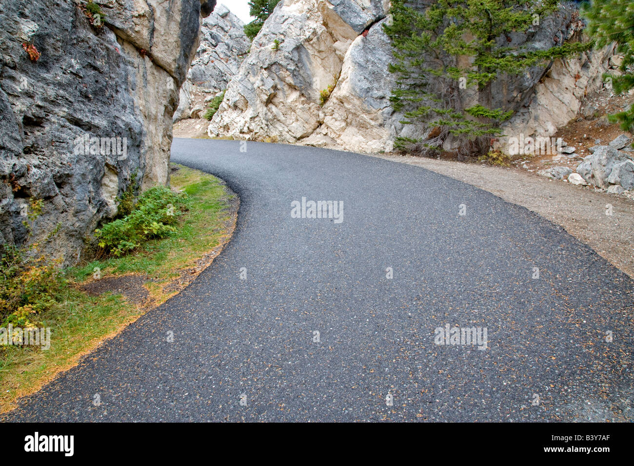 Small paved road in rock outcropping Yellowstone National Park WY Stock ...