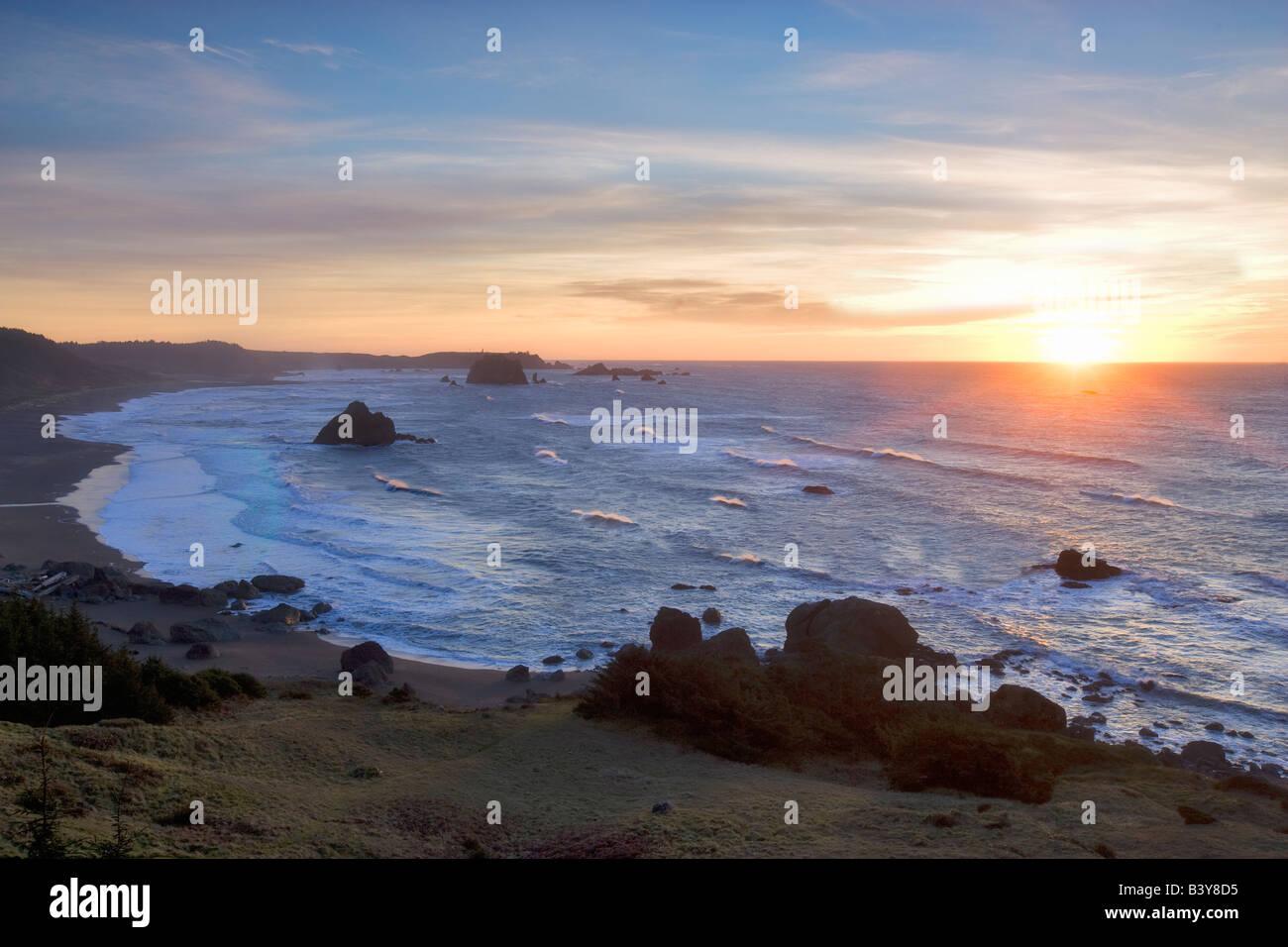 Sunset and waves off Blacklock Point with Cape Blanco in background ...