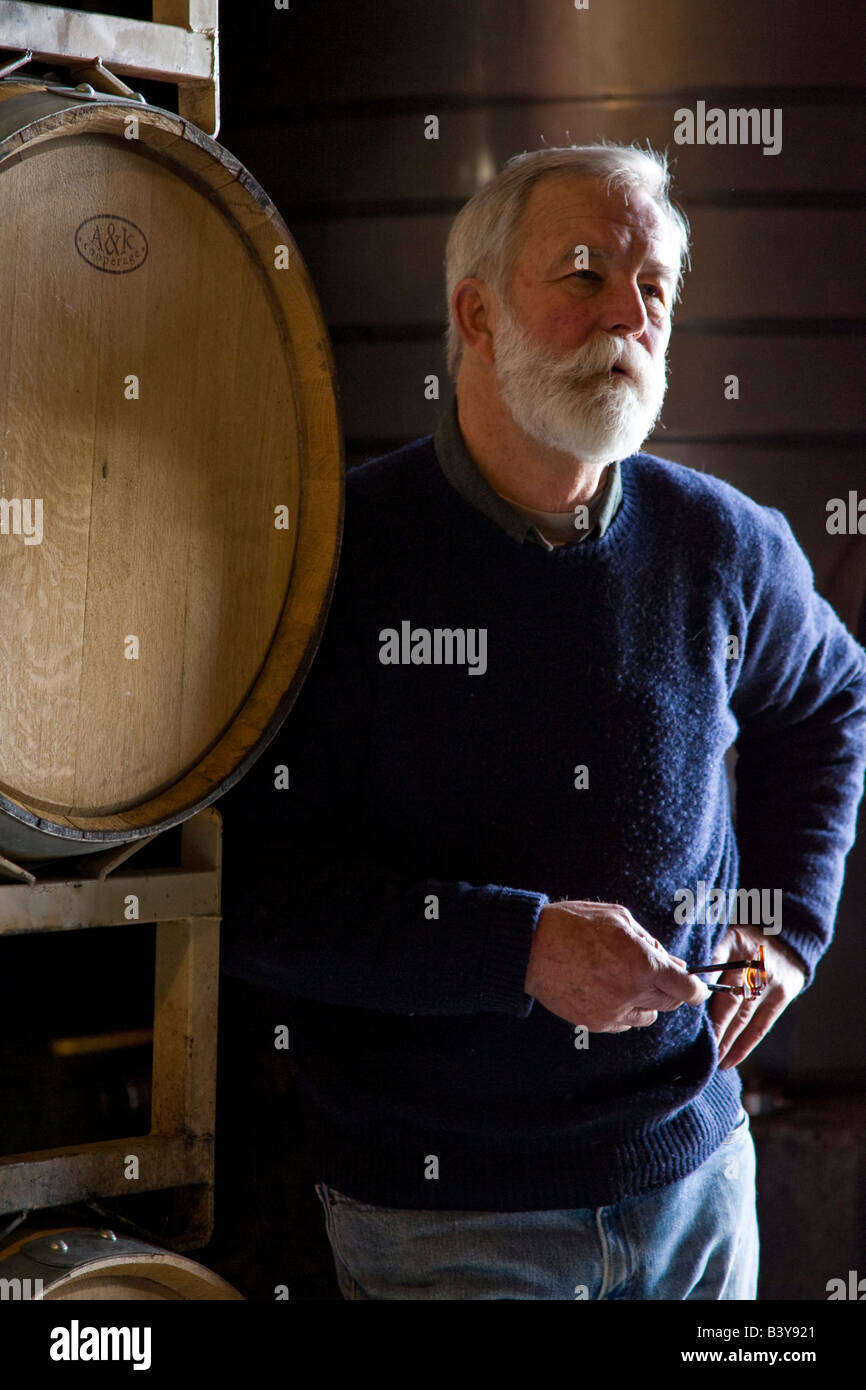 USA, California, Napa Valley. A male wine maker discusses the process ...