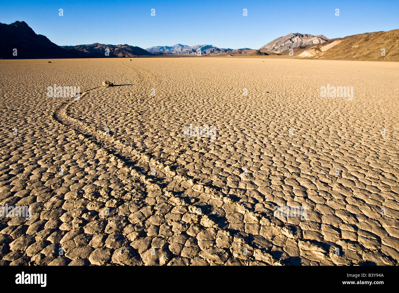 USA, California, Death Valley National Park. Rock and trail at the base ...