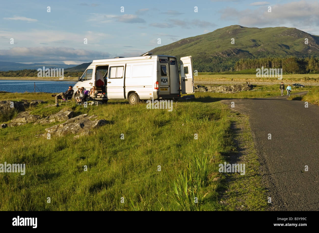 Scotland, Hebrides, Mull. A family on a camping holiday sit outside ...