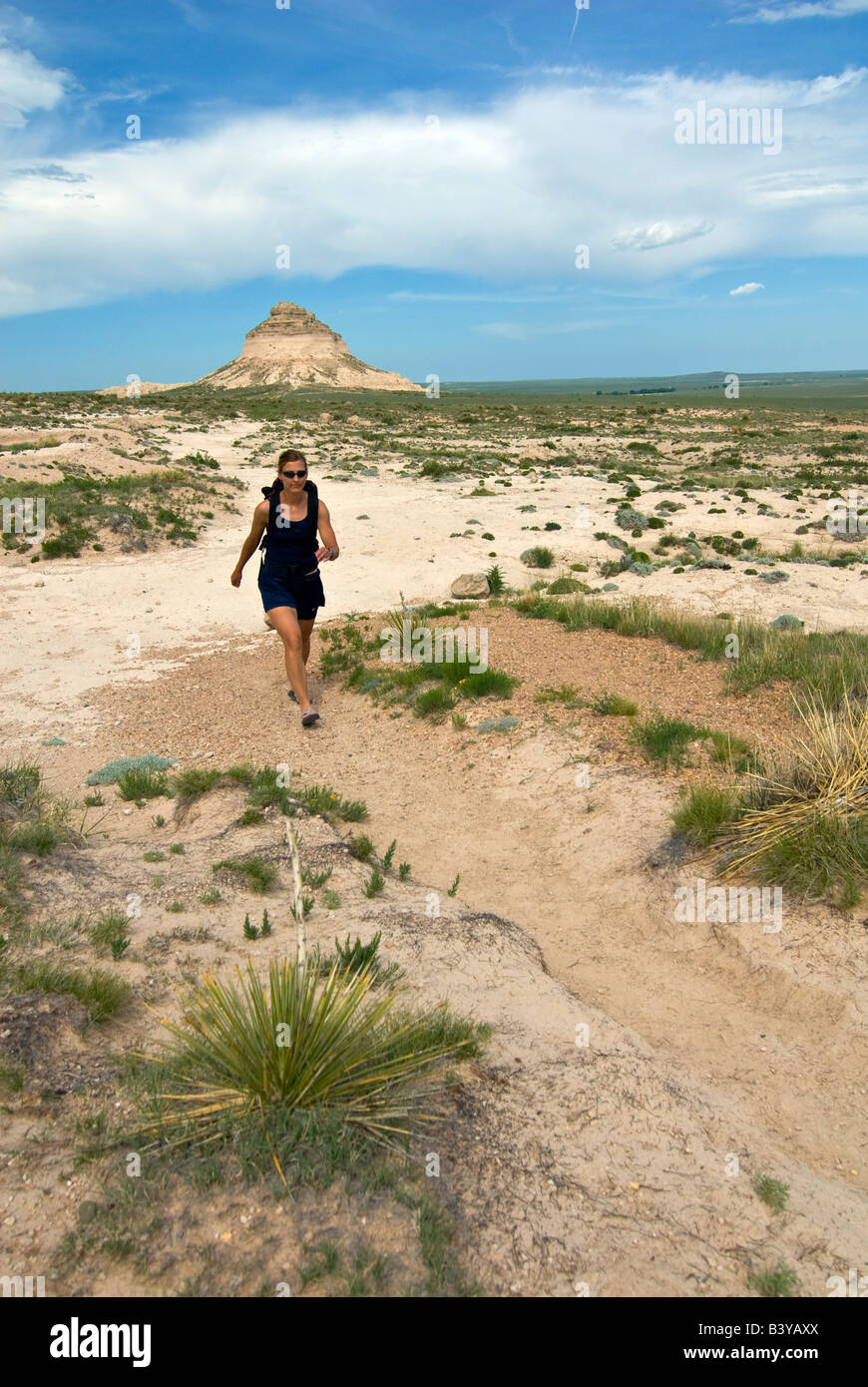 USA, Colorado, Pawnee Buttes. Woman hiking on a summer afternoon. (MR ...