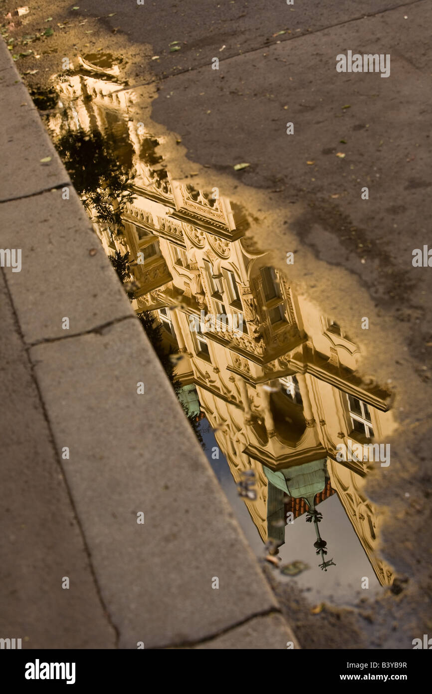 House fronts reflect in a puddle of water Stock Photo - Alamy