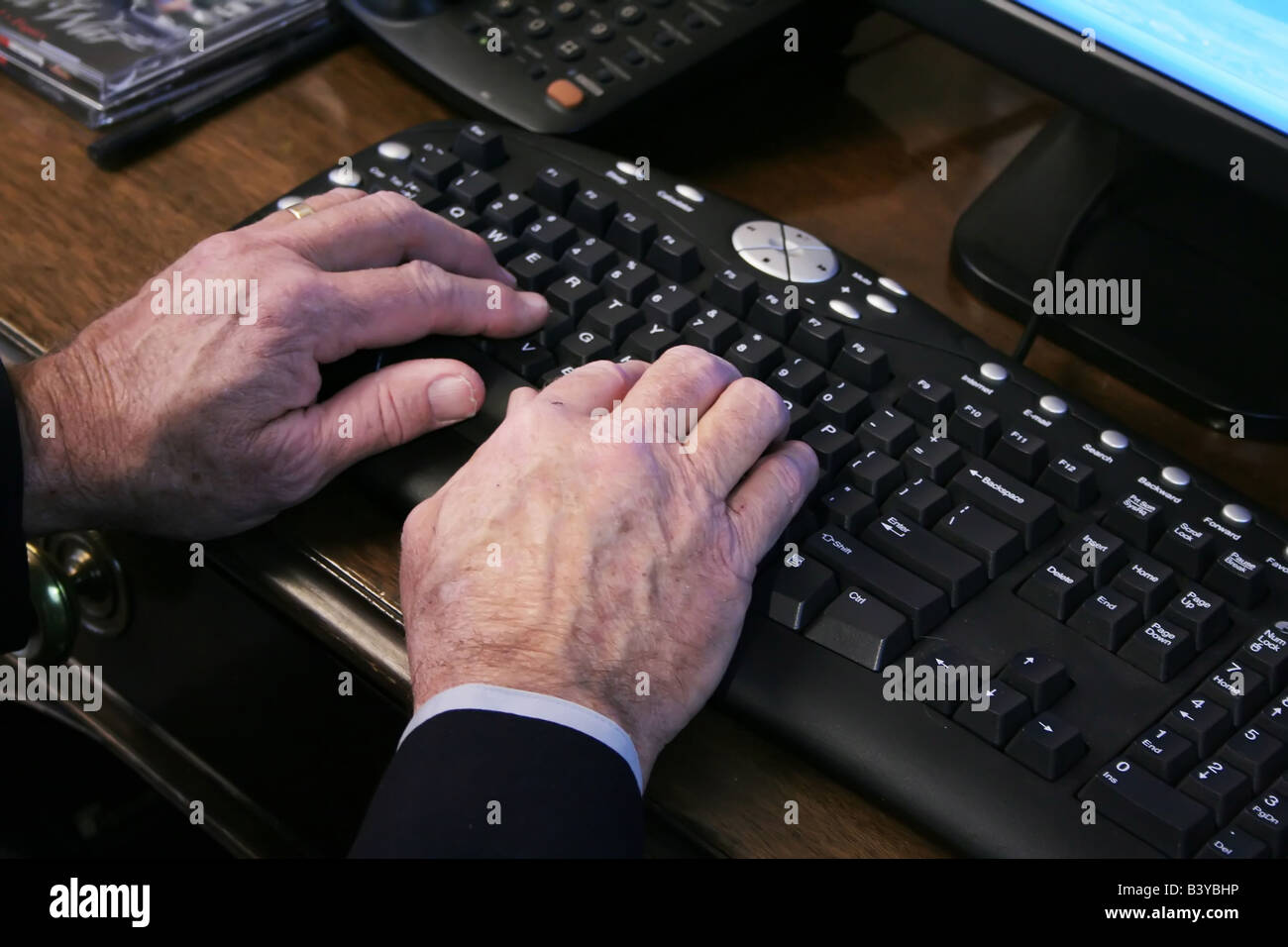 Elderly hands typing on keyboard Stock Photo - Alamy
