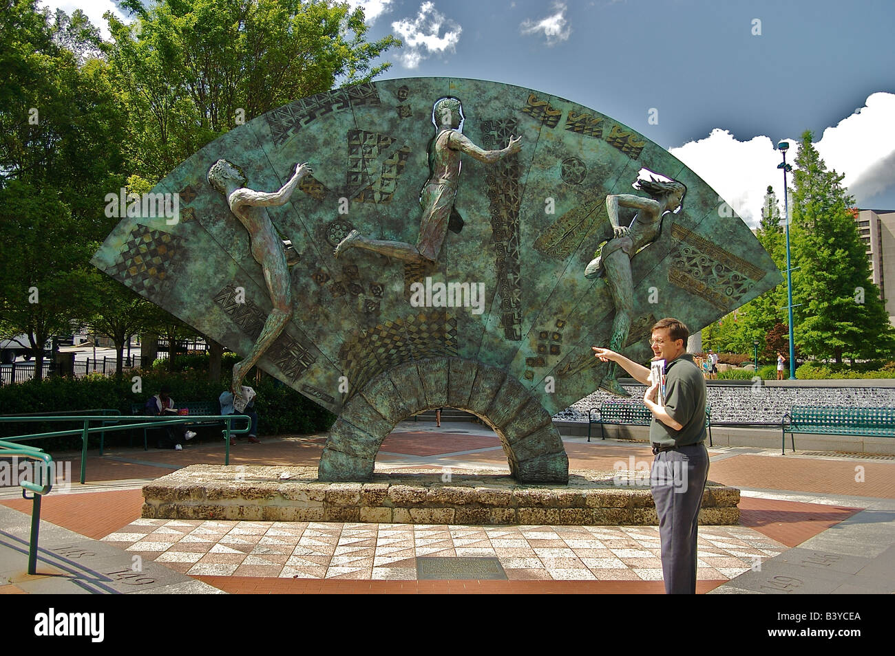 North America, USA, Georgia, Atlanta. Man pointing to a sculpture at ...