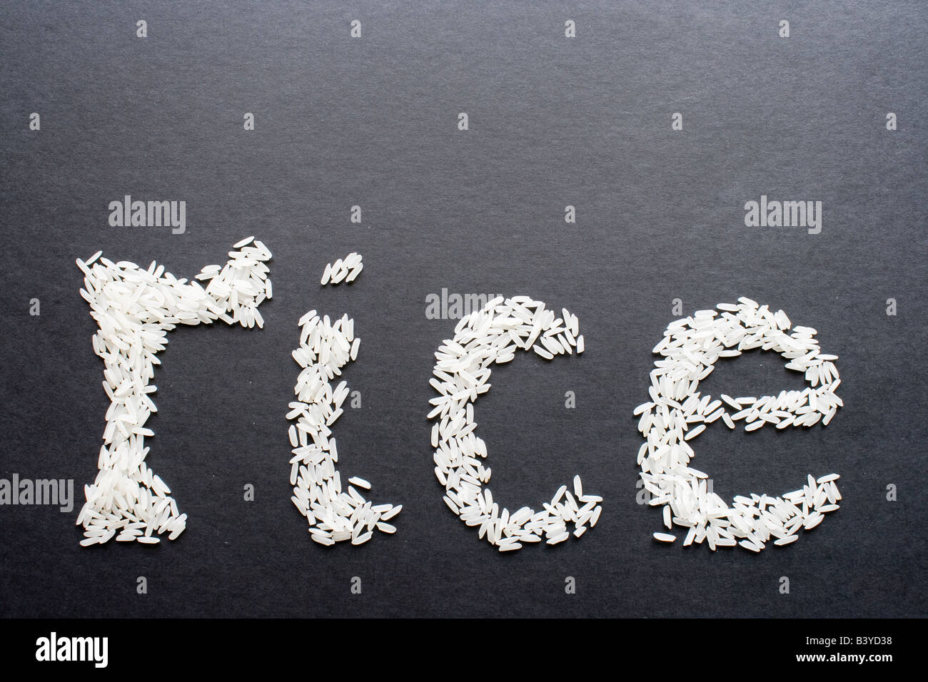 Rice grains spelling the word rice on a dark background Stock Photo - Alamy