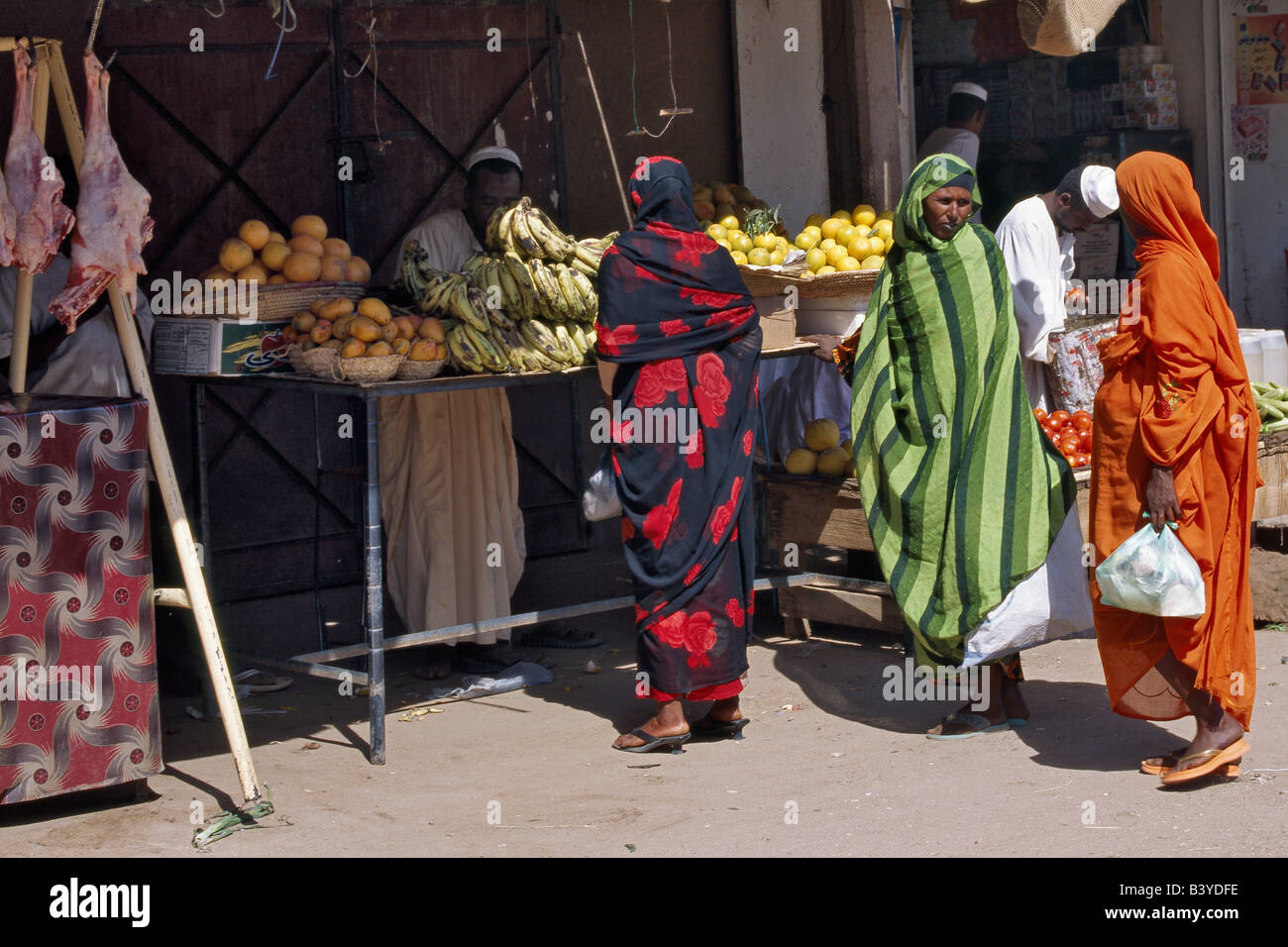 Sudan, Shendi. A fruit stall and butchery selling legs of mutton in the ...