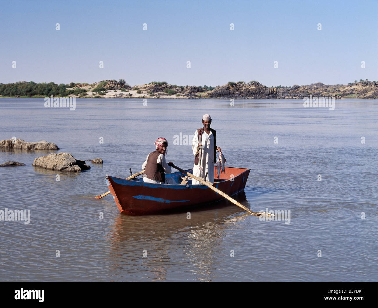 Sudan, River Nile, 4th Cataract. Nubian fishermen proudly show-off ...