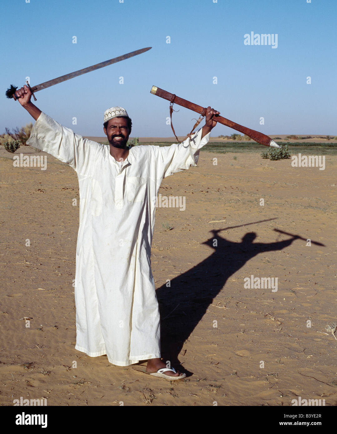 Sudan, Sahara Desert, A Nubian man displays his sword at an oasis in ...