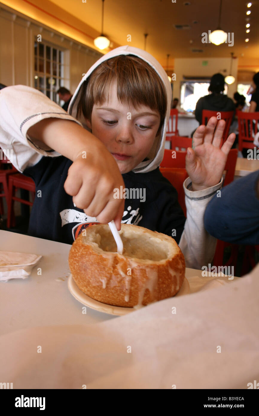 child eating clam chowder soup out of sourdough bread bowl Stock Photo ...