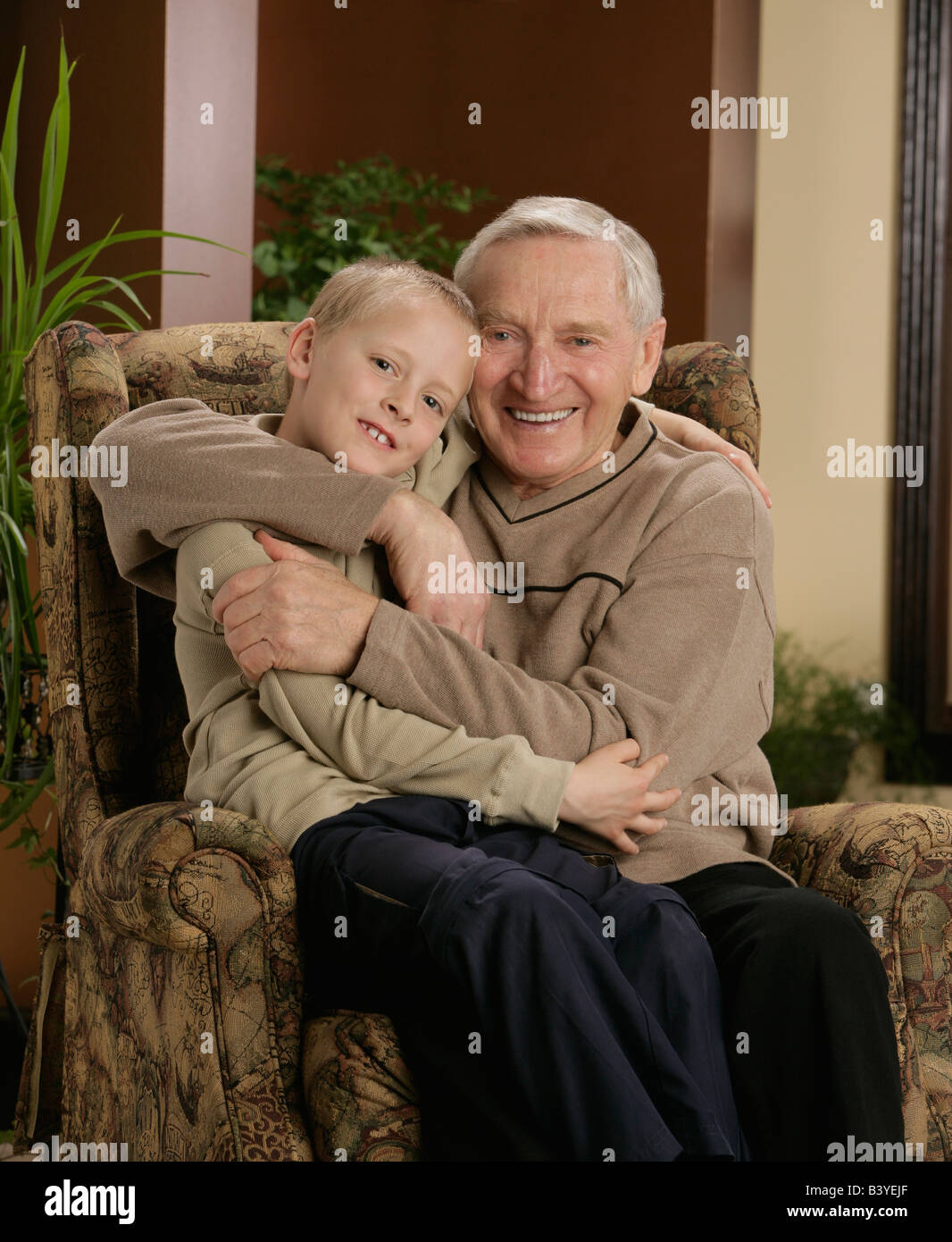 Grandfather hugging grandson Stock Photo - Alamy
