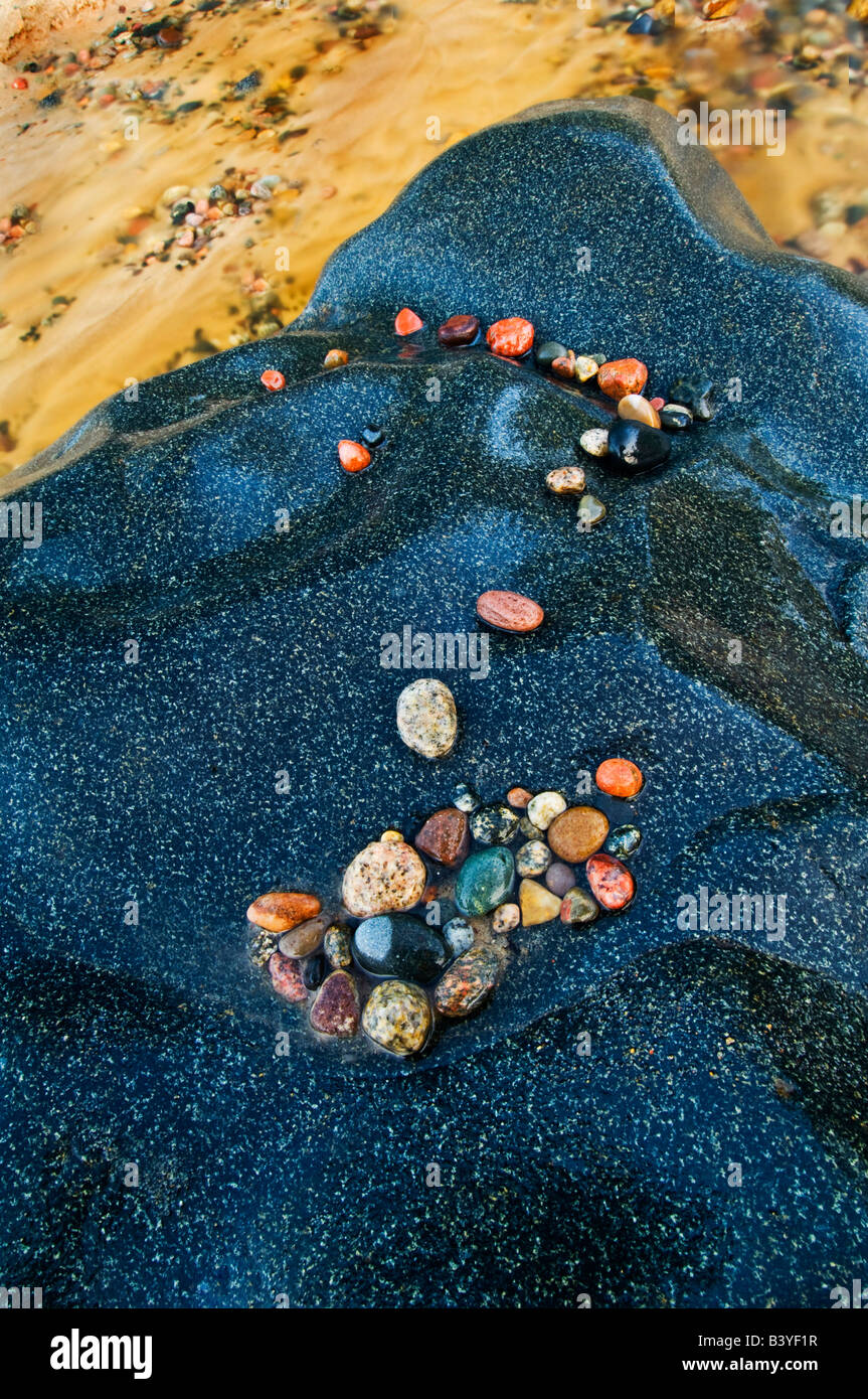 USA, Michigan, Upper Peninsula. Lake Superior rocks on beach Stock ...
