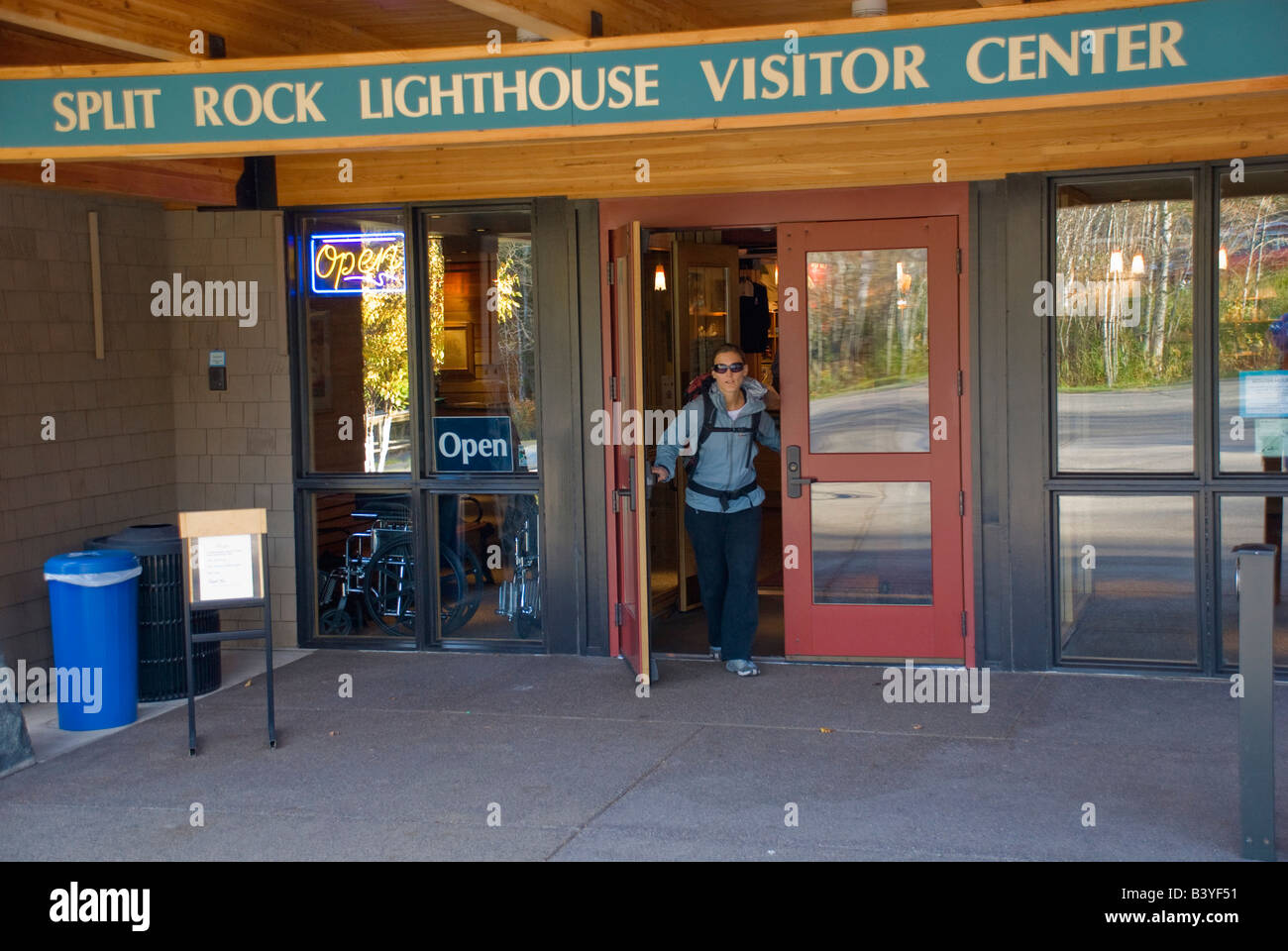 USA, Minnesota. A woman exits the Split Rock Lighthouse Visitor Center ...