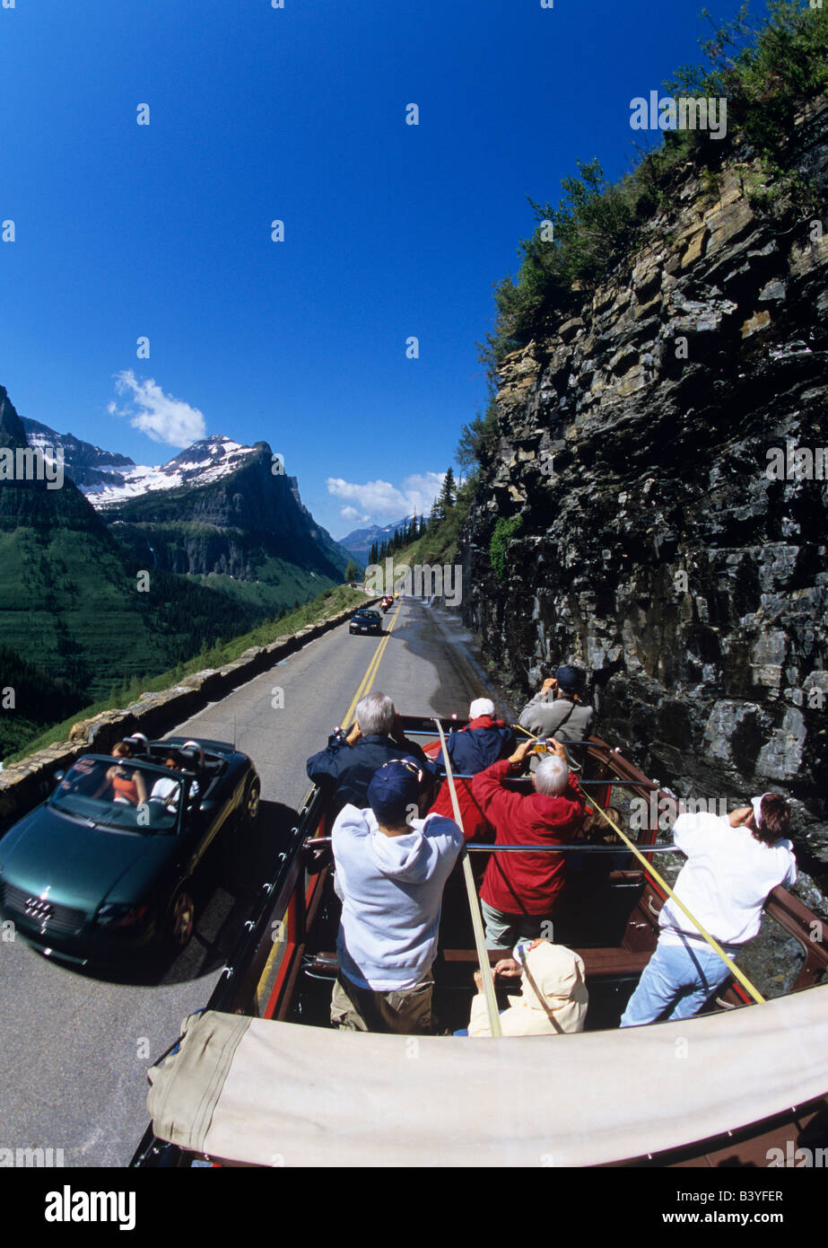 Red jammer bus on going to the Sun Road near the Weeping Wall in ...