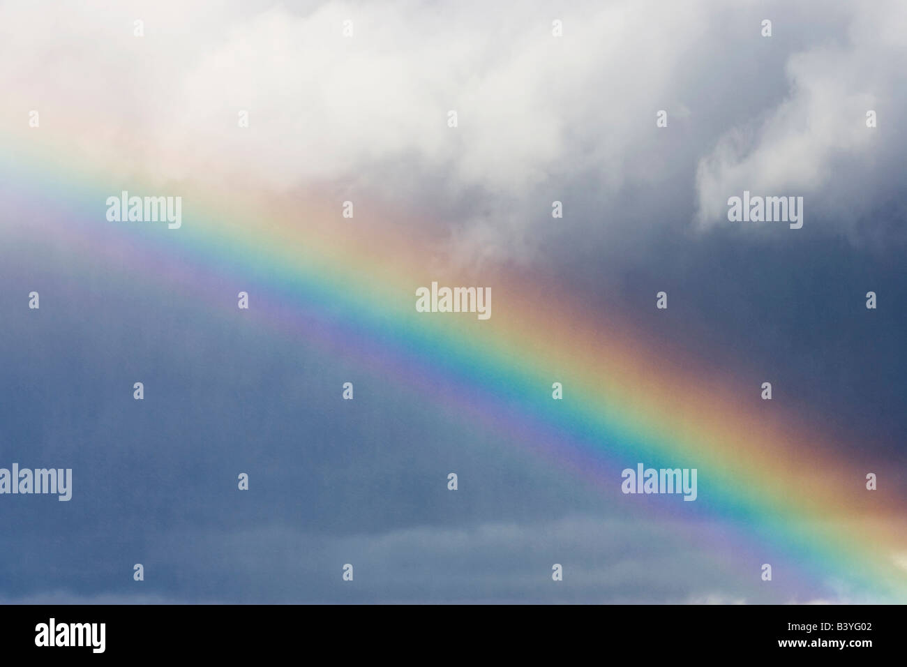 Photo of a rainbow breaking through a storm Stock Photo - Alamy