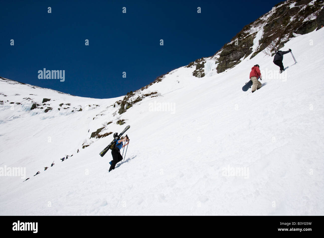 Skiers climbing Tuckerman Ravine in New Hampshire's White Mountains ...